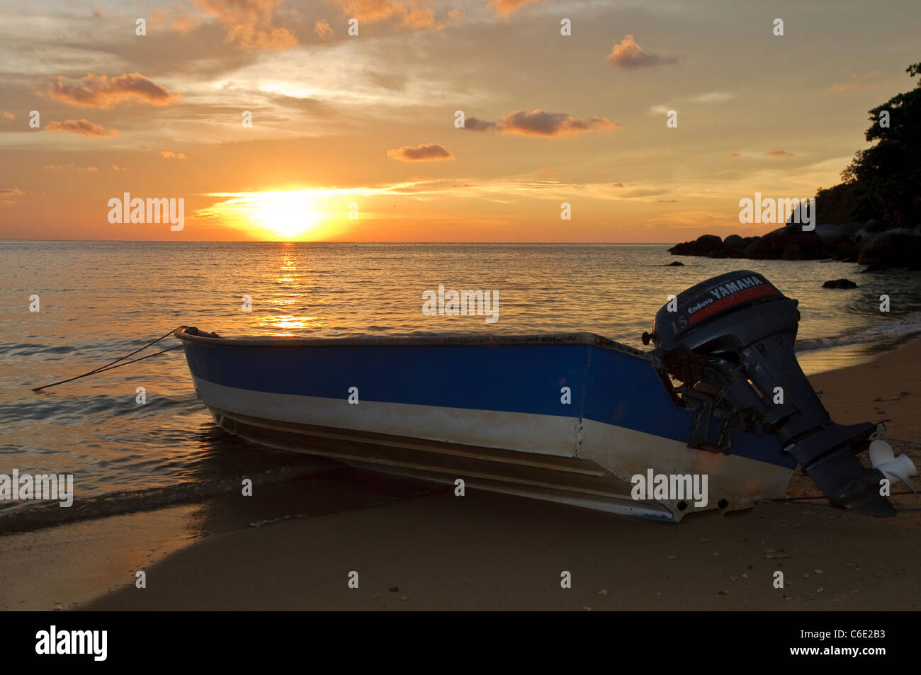 Motorboat at sunset on the beach of Panuba, Pulau Tioman Island ...