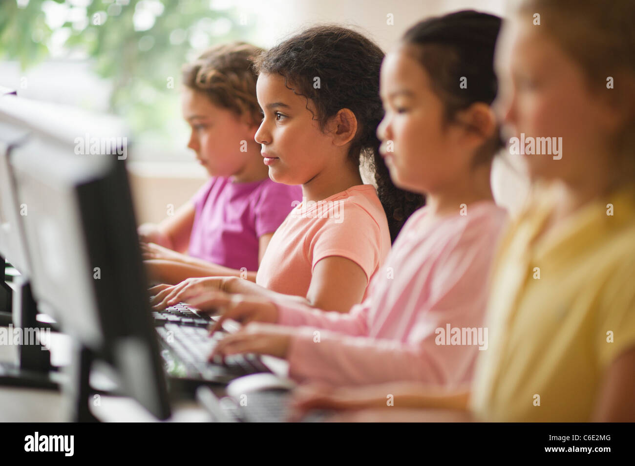 USA, New Jersey, Jersey City, four girls using computers Stock Photo ...