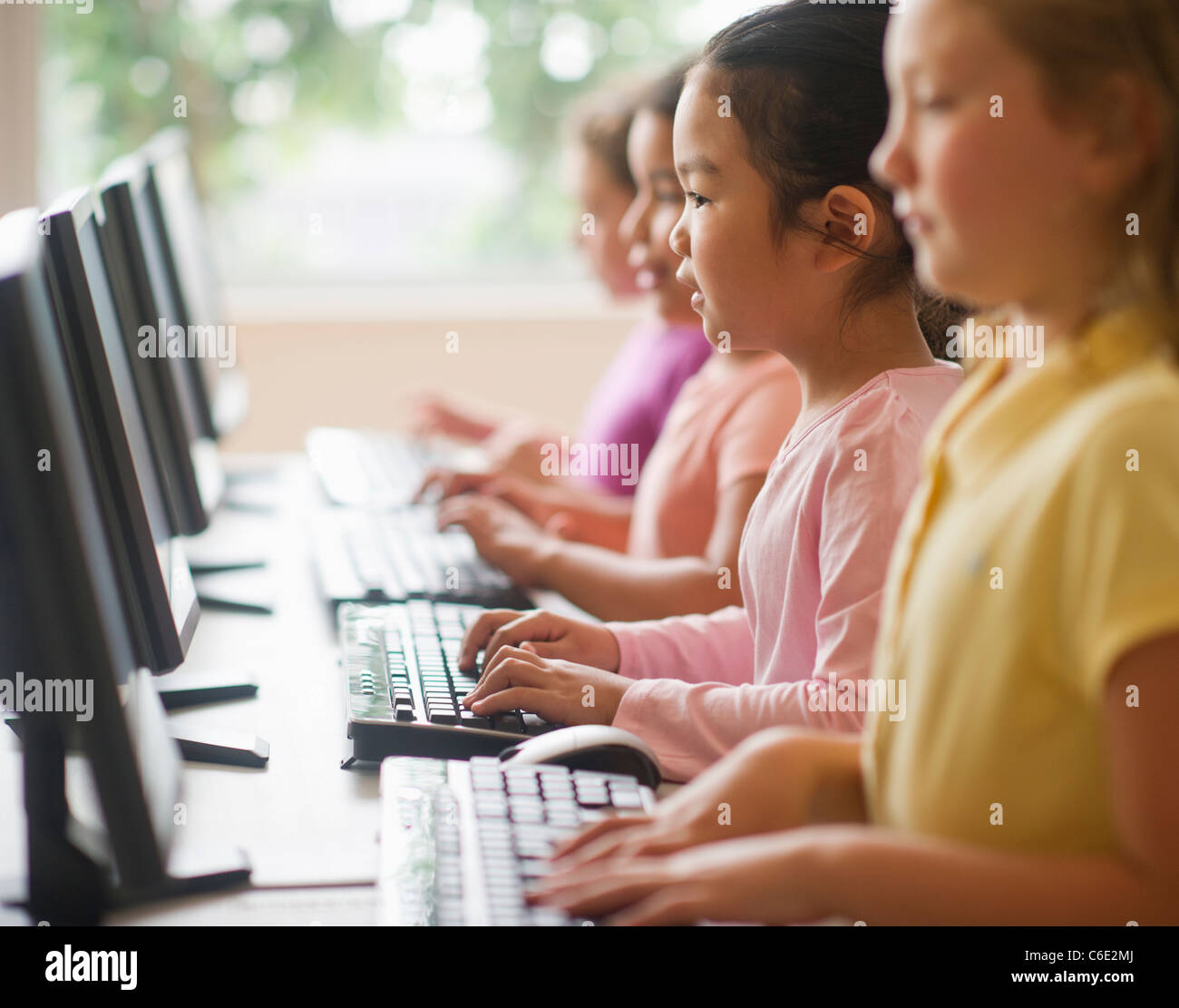 USA, New Jersey, Jersey City, four girls using computers Stock Photo ...