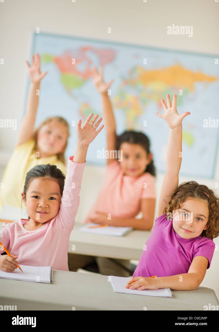 Children in classroom raising hands hi-res stock photography and images ...