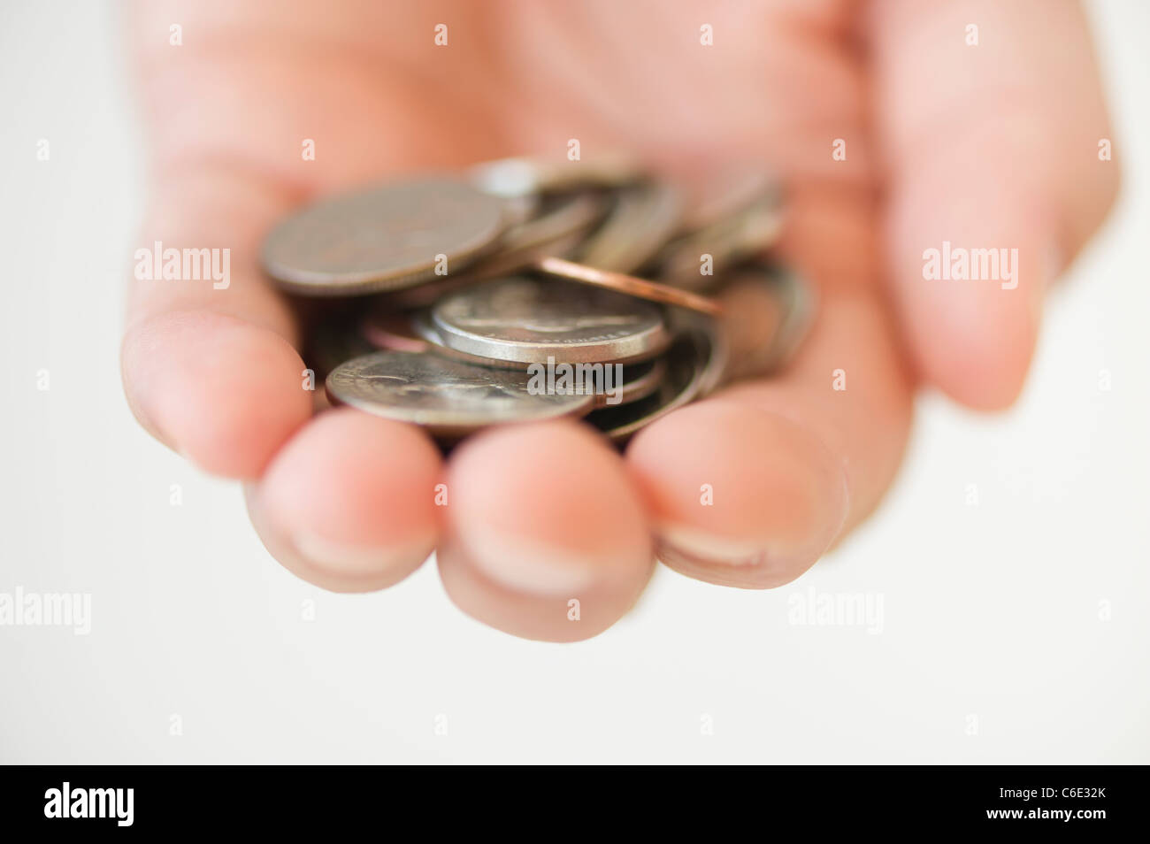 Hand holding coins Stock Photo - Alamy