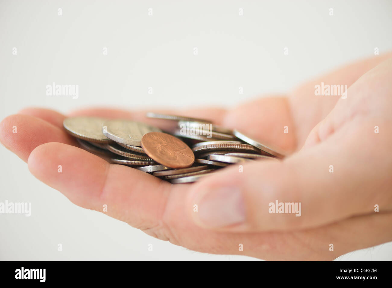 Hand holding coins Stock Photo - Alamy