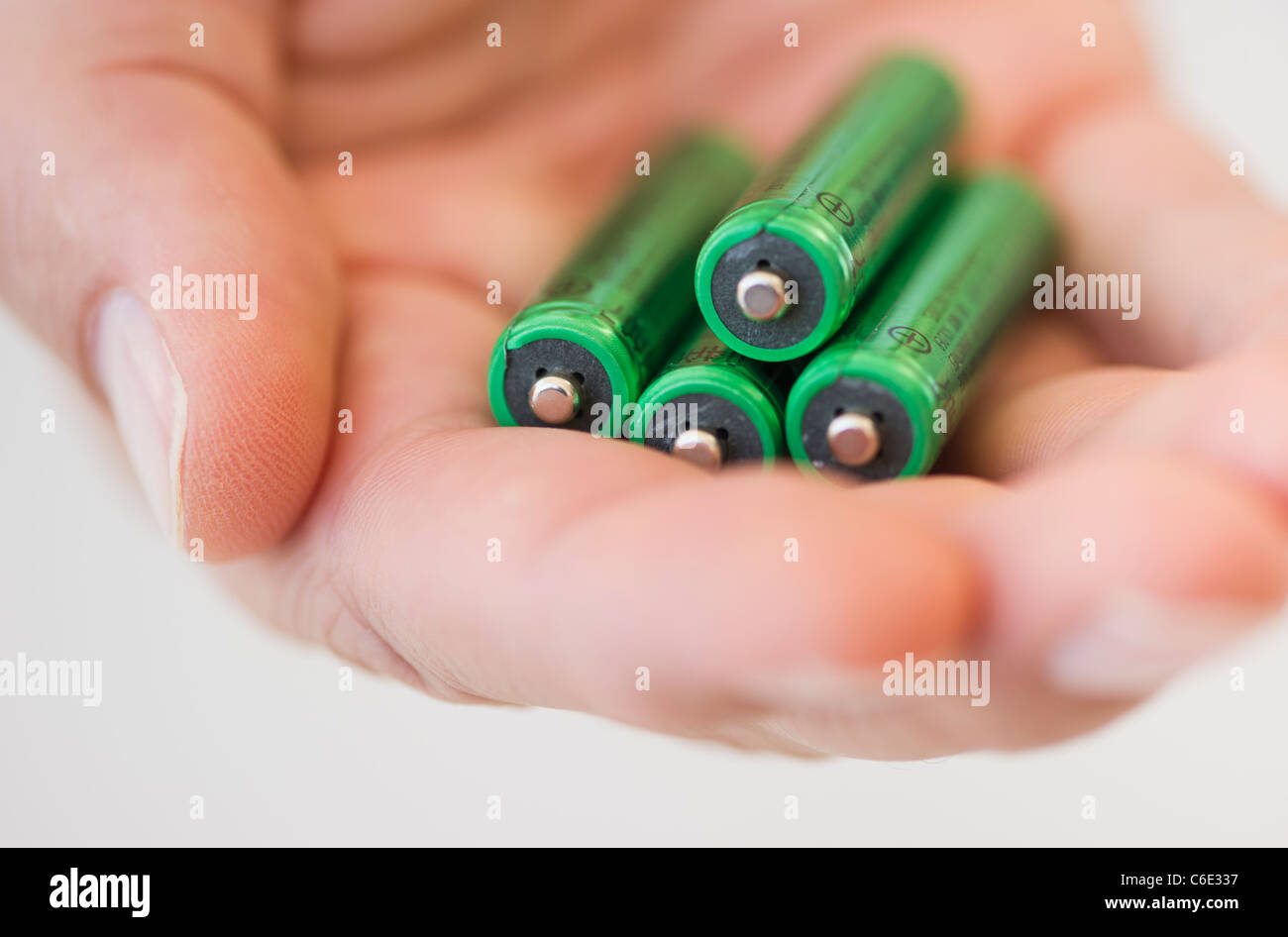 Hand holding batteries Stock Photo - Alamy