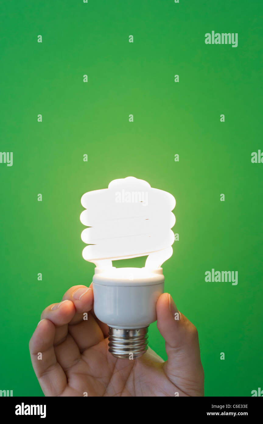 Hand holding lightbulb Stock Photo - Alamy