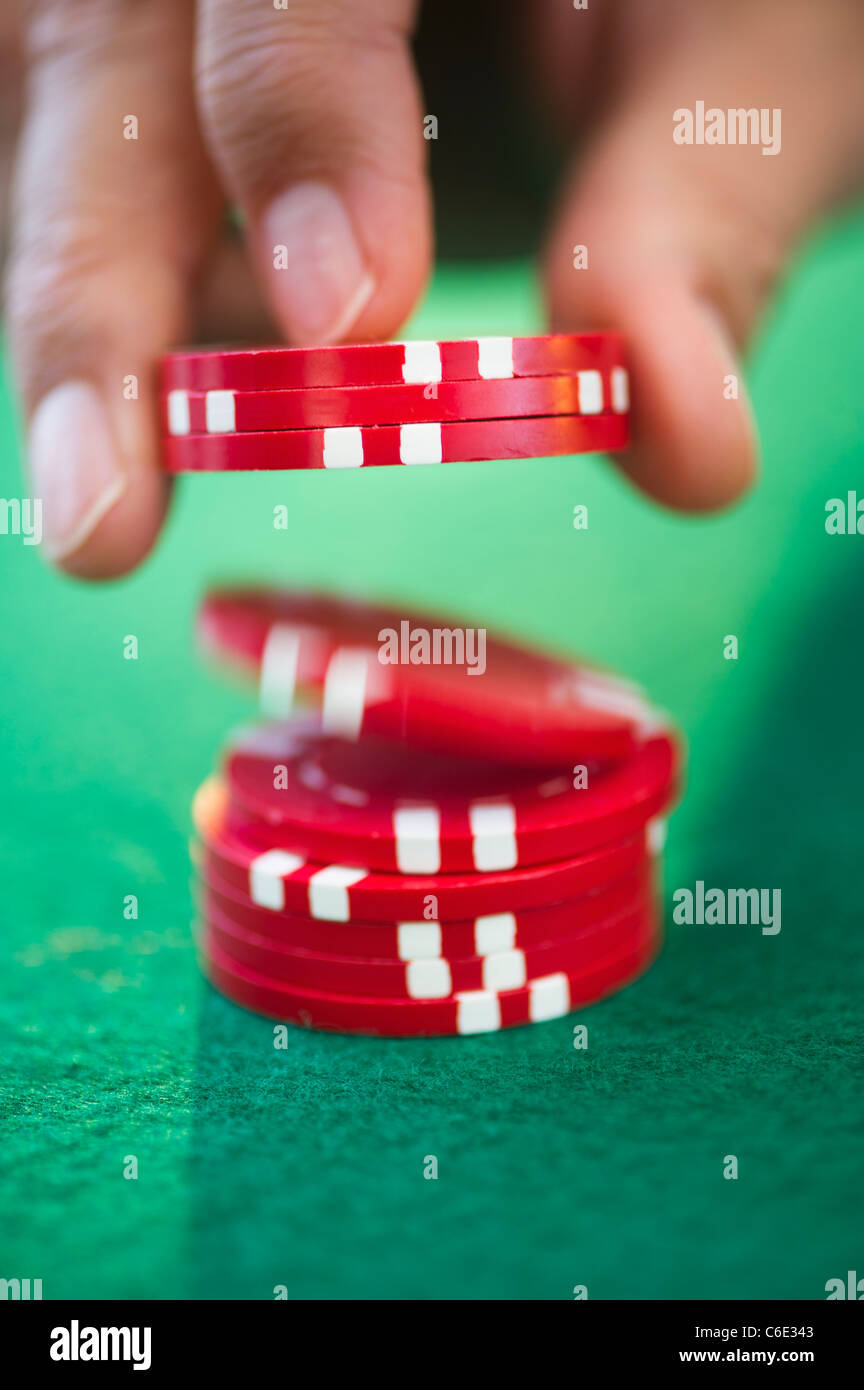 Hand handling gambling chips Stock Photo - Alamy