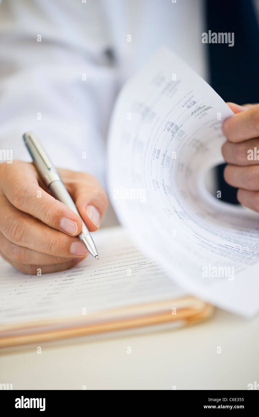 Businessman writing, close-up Stock Photo - Alamy