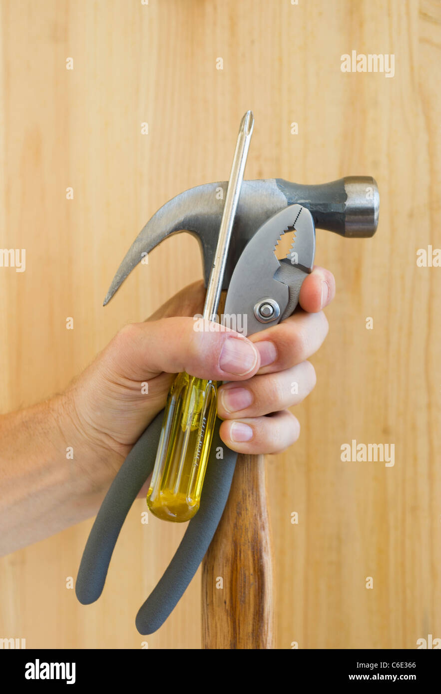Hand holding tools Stock Photo - Alamy