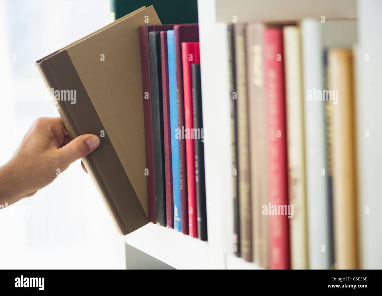 Person selecting books from library hi-res stock photography and images ...