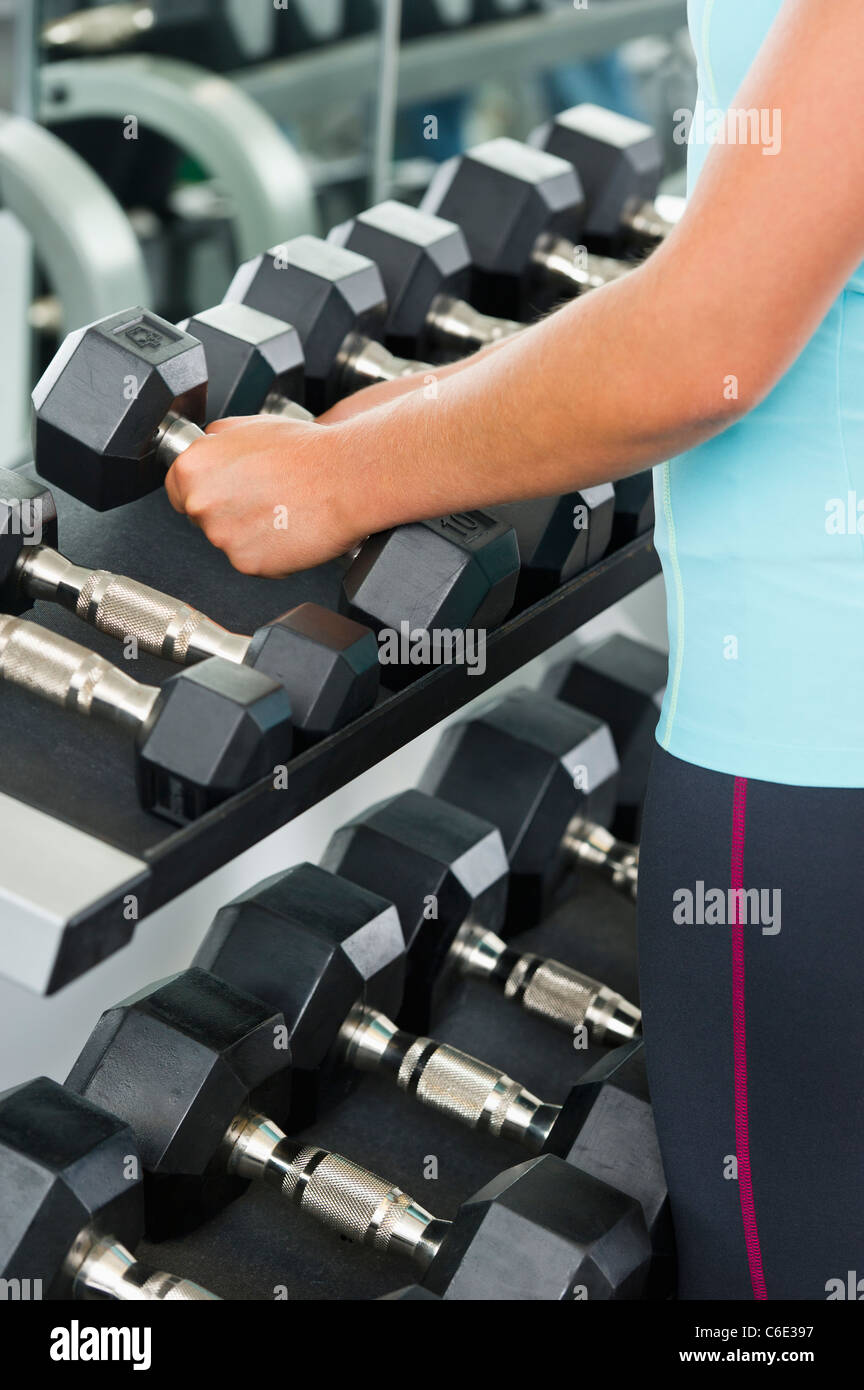 Woman lifting dumbbells Stock Photo - Alamy