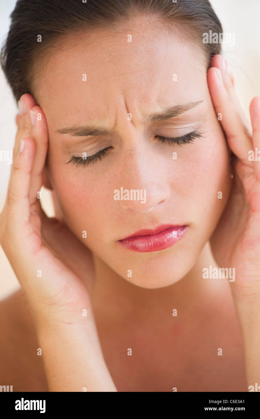 Young woman with head in hands Stock Photo - Alamy