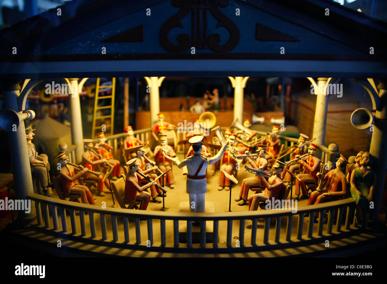 Antique animated wooden band in a bandstand playing music at night ...
