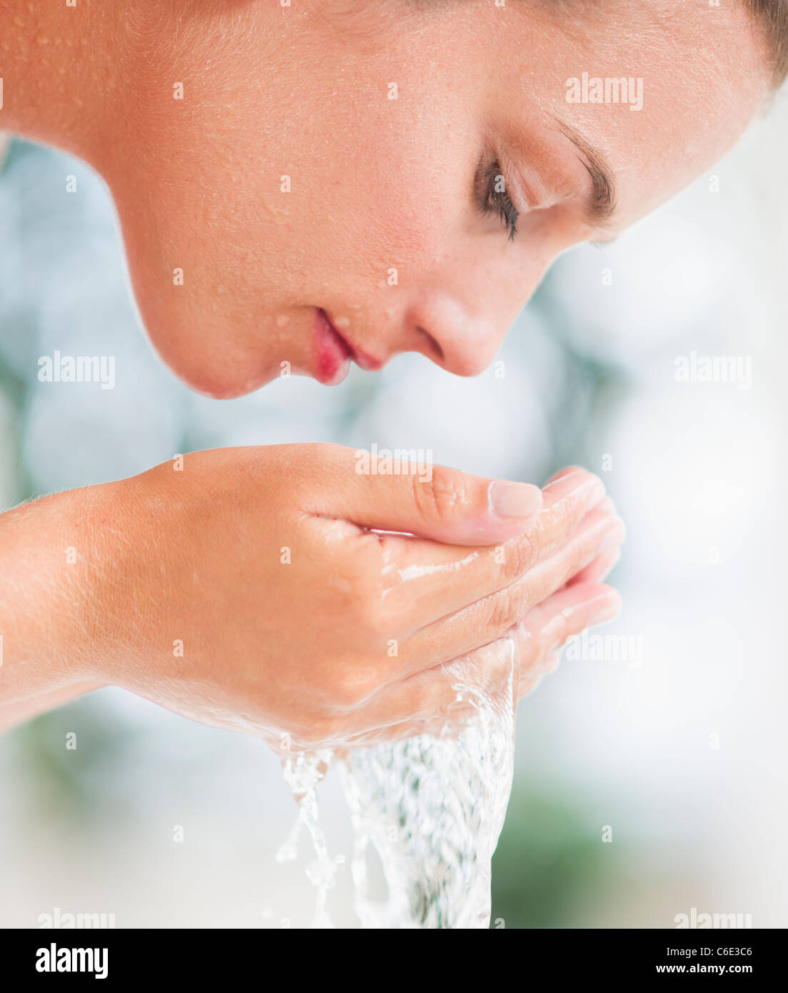 Woman washing face Stock Photo - Alamy