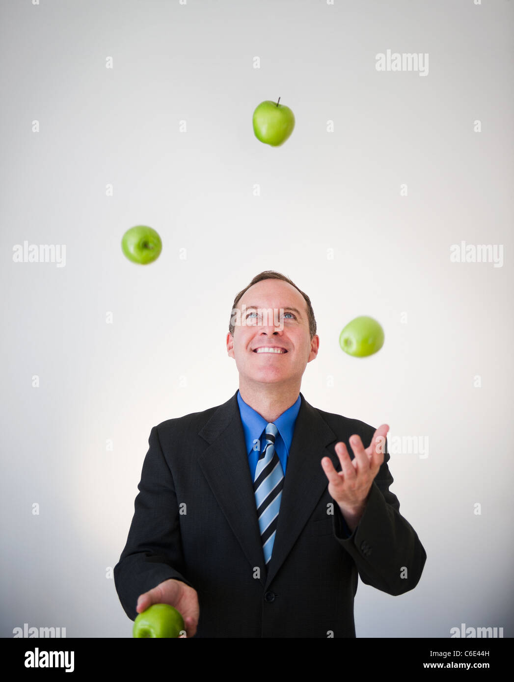 USA, New Jersey, Jersey City, Businessman juggling apples Stock Photo ...