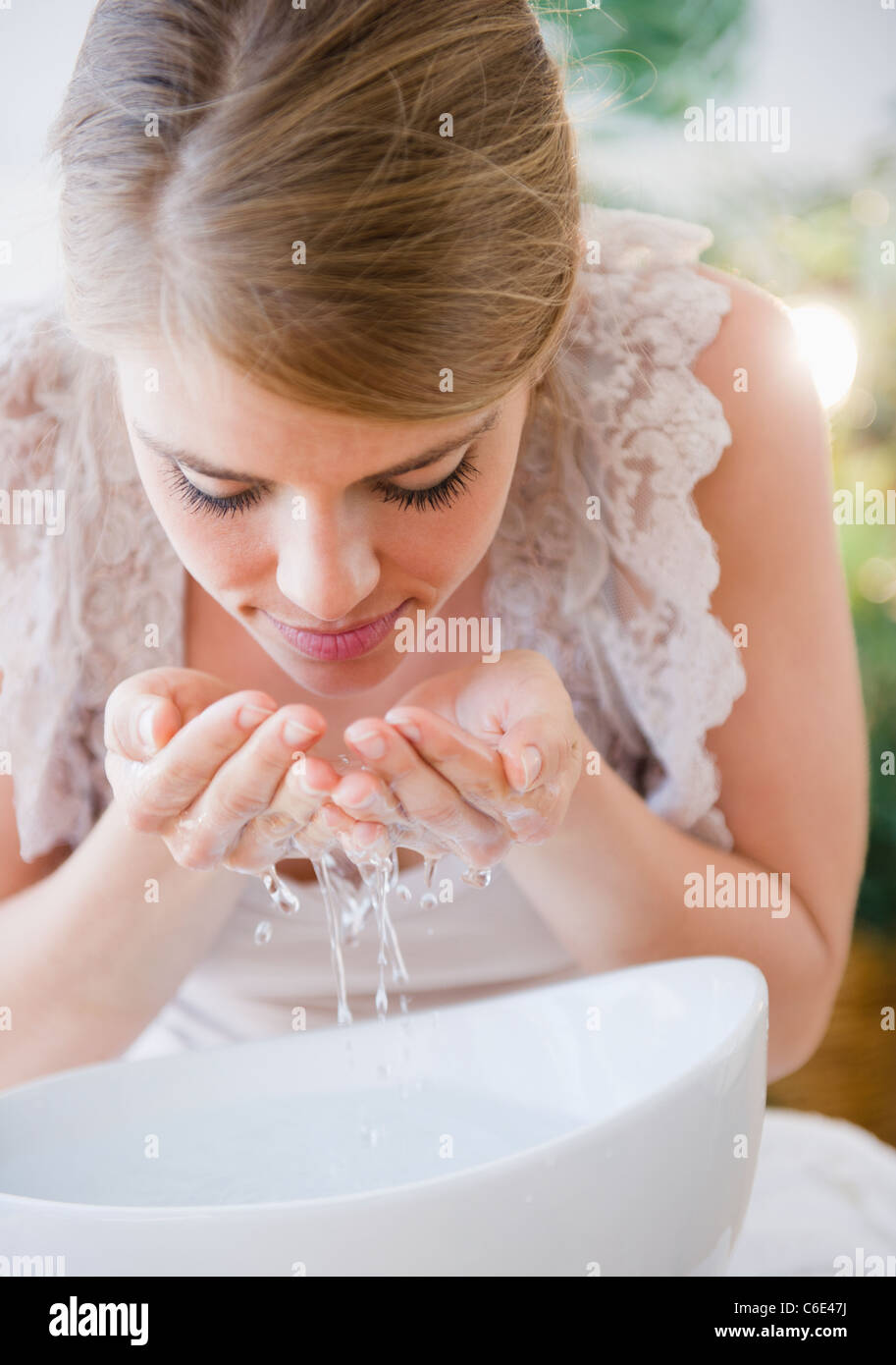 USA, New Jersey, Jersey City, Woman washing face with water Stock Photo ...