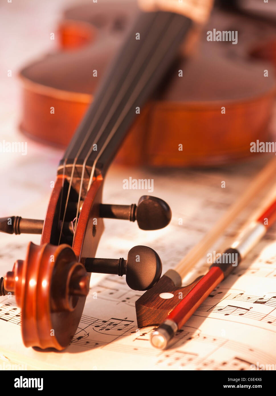 Close up of violin scroll and bow on sheet music Stock Photo - Alamy