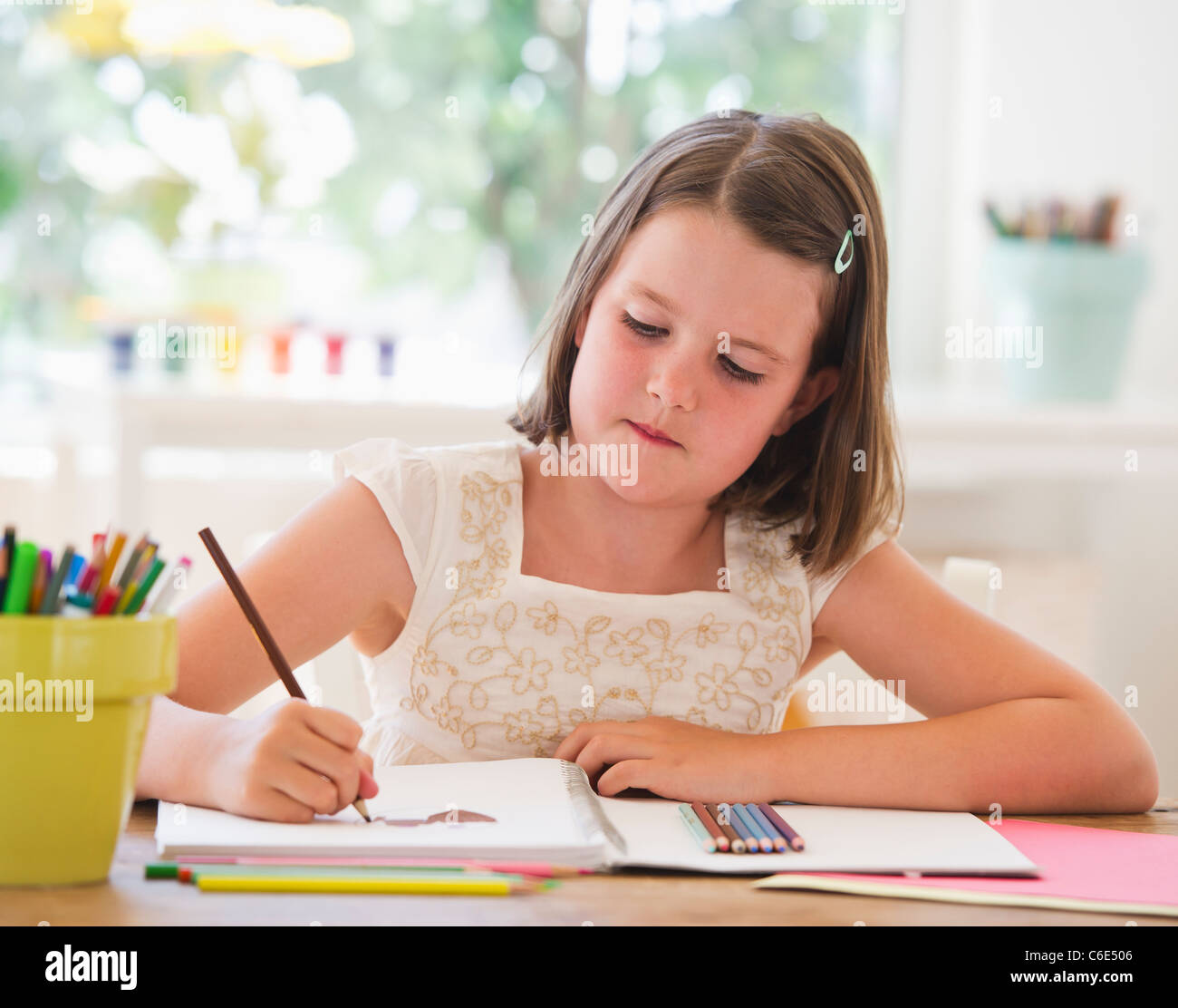 USA, New Jersey, Jersey City, Close up of girl drawing in notebook ...