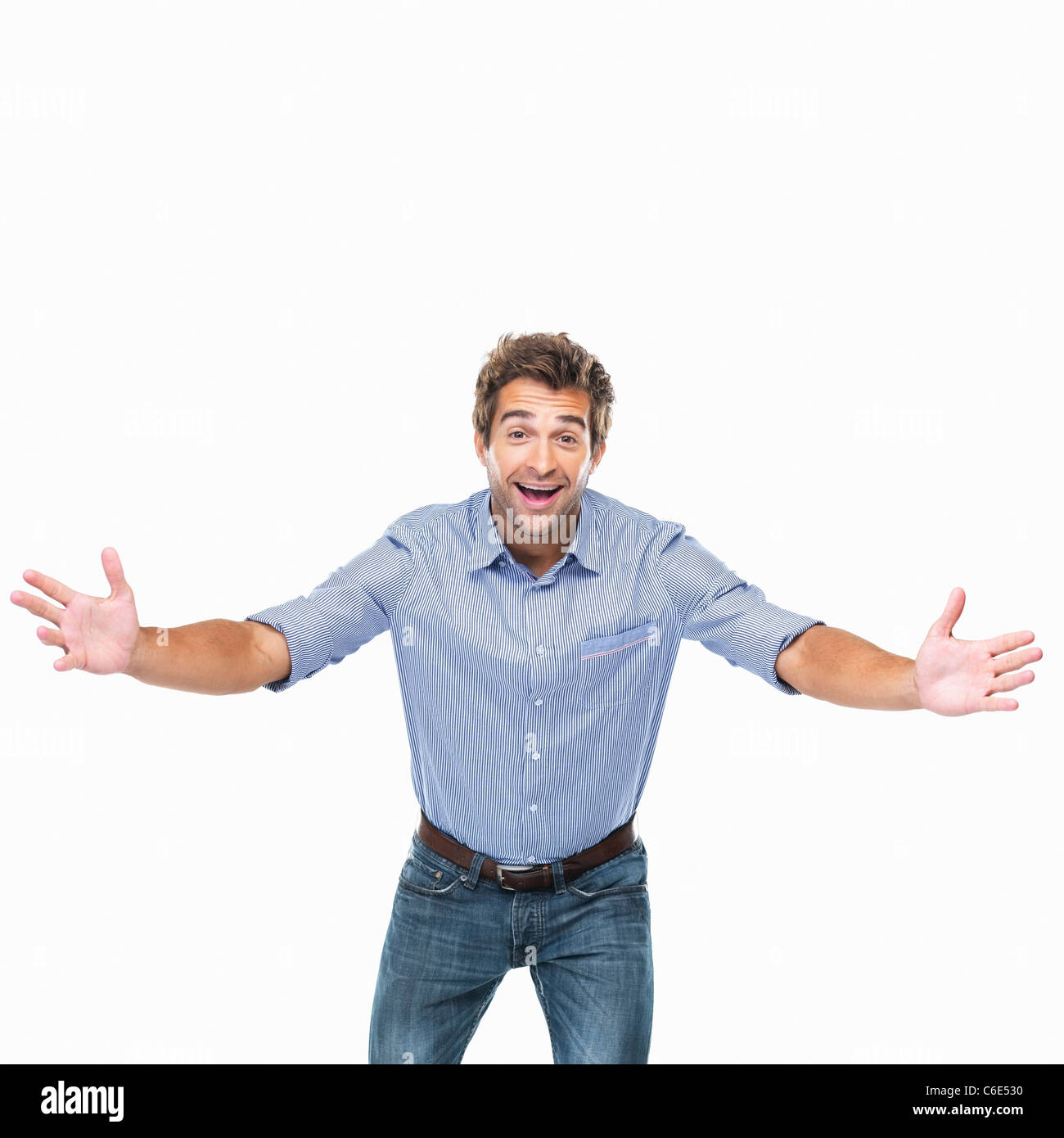 Studio shot of young cheerful man with arms outstretched Stock Photo ...