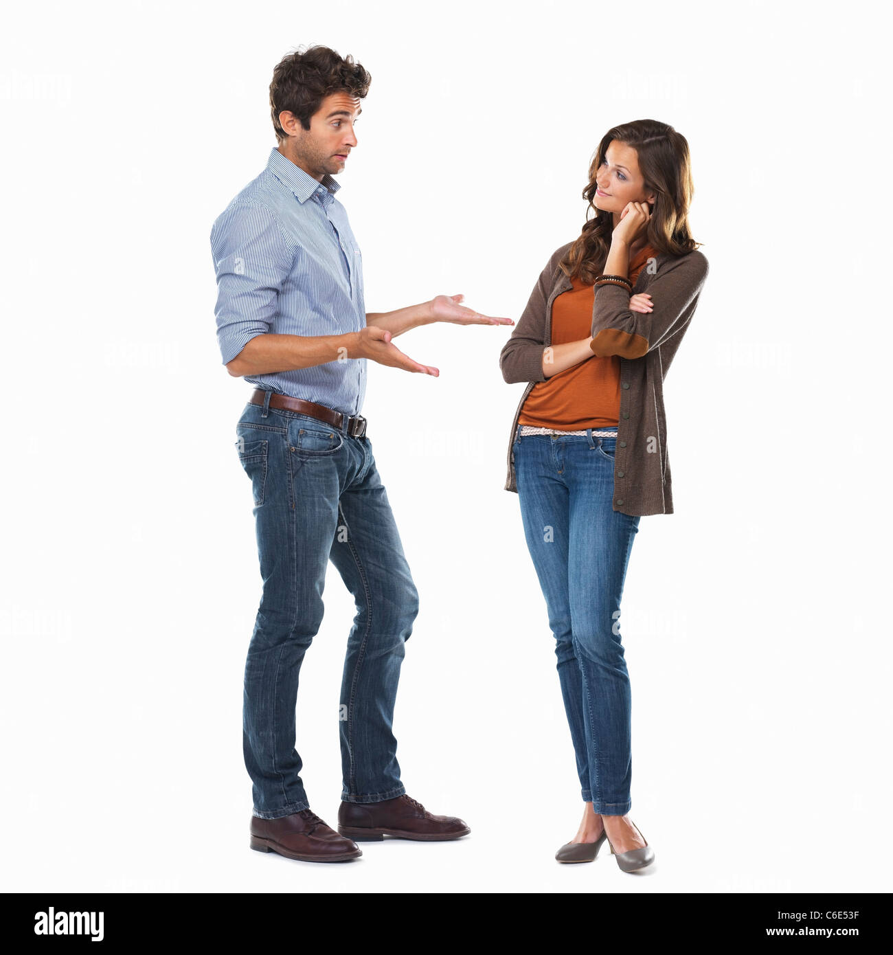 Studio shot of young couple having conversation Stock Photo - Alamy