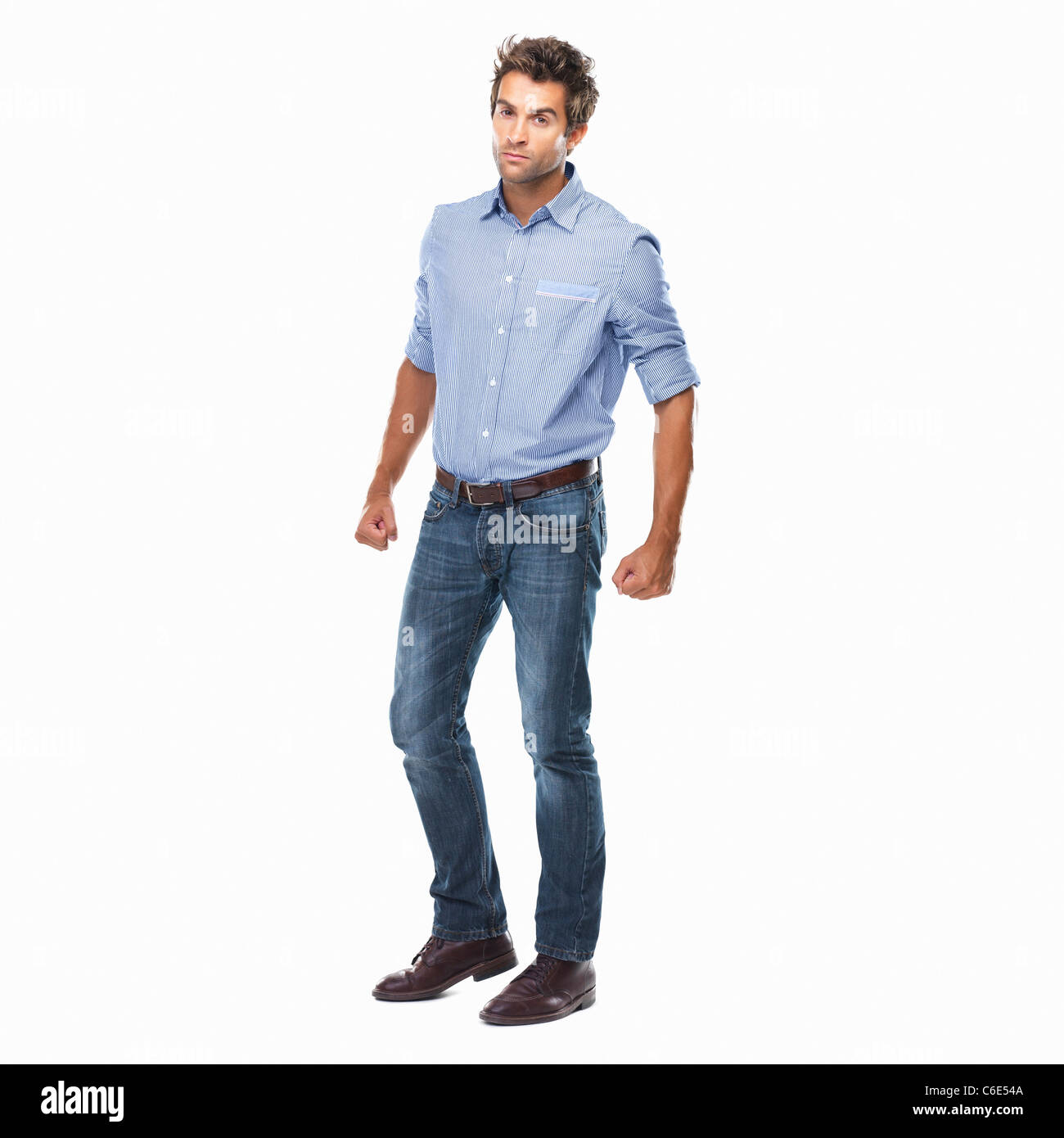 Studio shot of young man ready to fight standing on white background ...