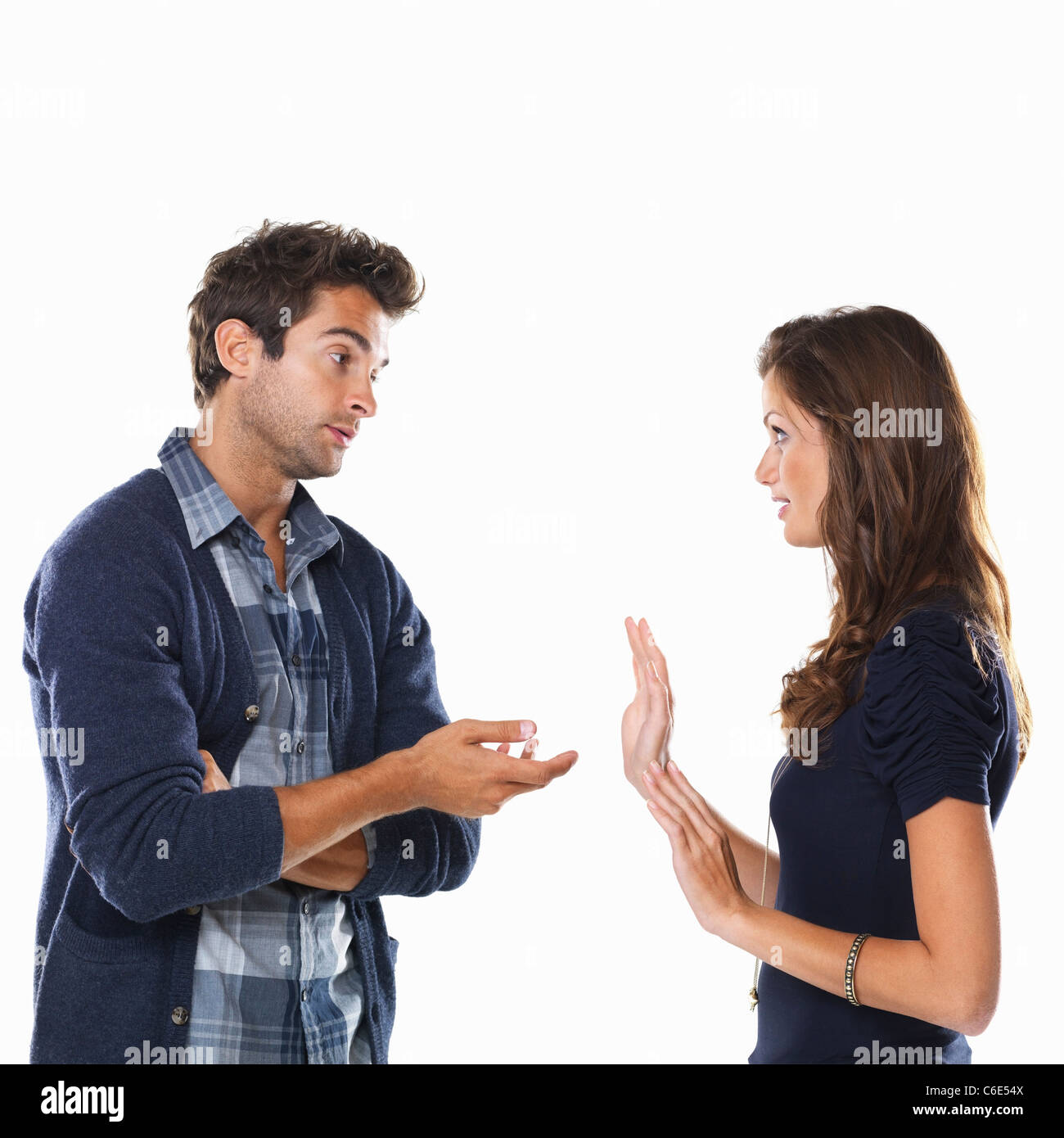 Studio shot of young couple having argument and gesturing Stock Photo ...