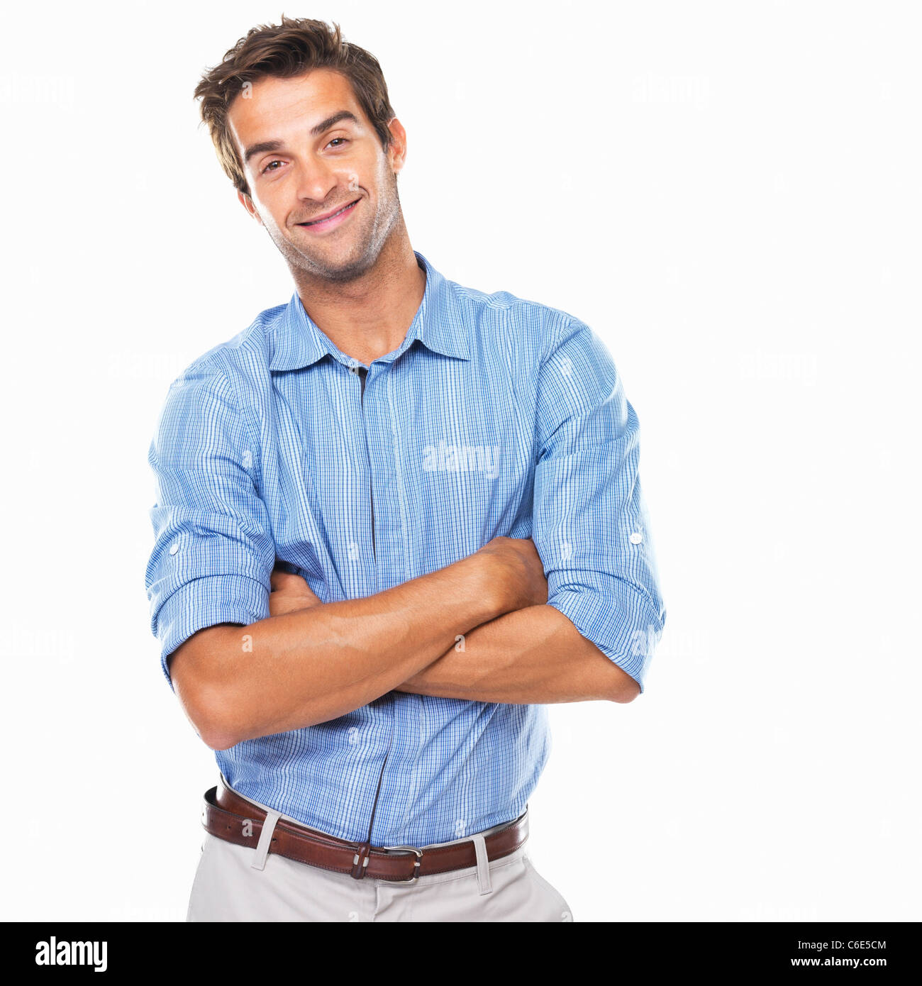 Portrait of young business man standing with hands folded and smiling ...