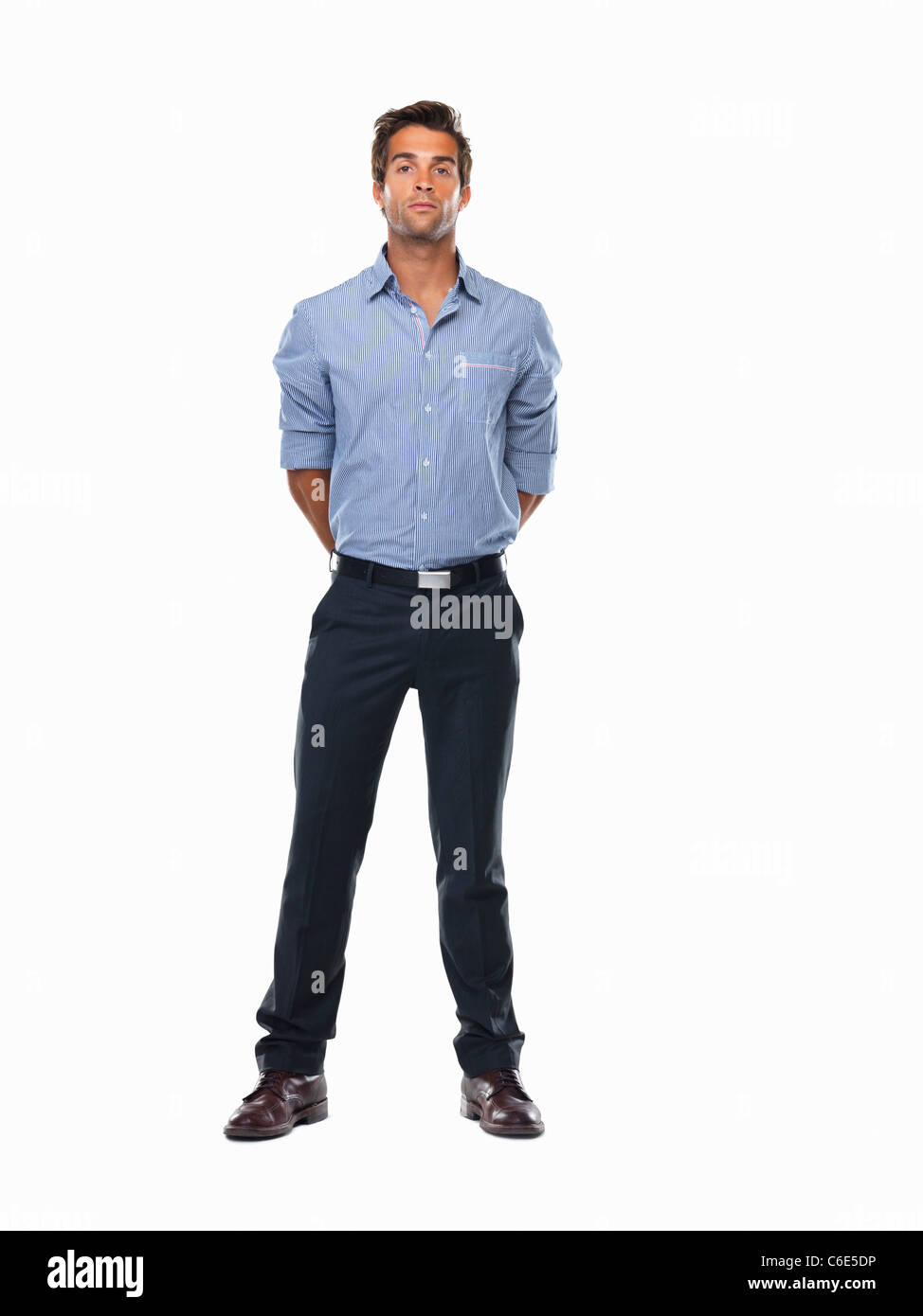 Studio shot of young business man standing with hands behind back Stock ...