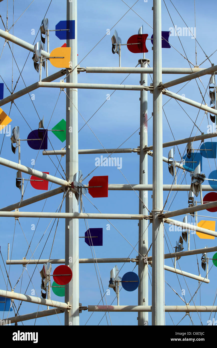 Brightly colored kinetic windmill sculpture on display at the beach in ...