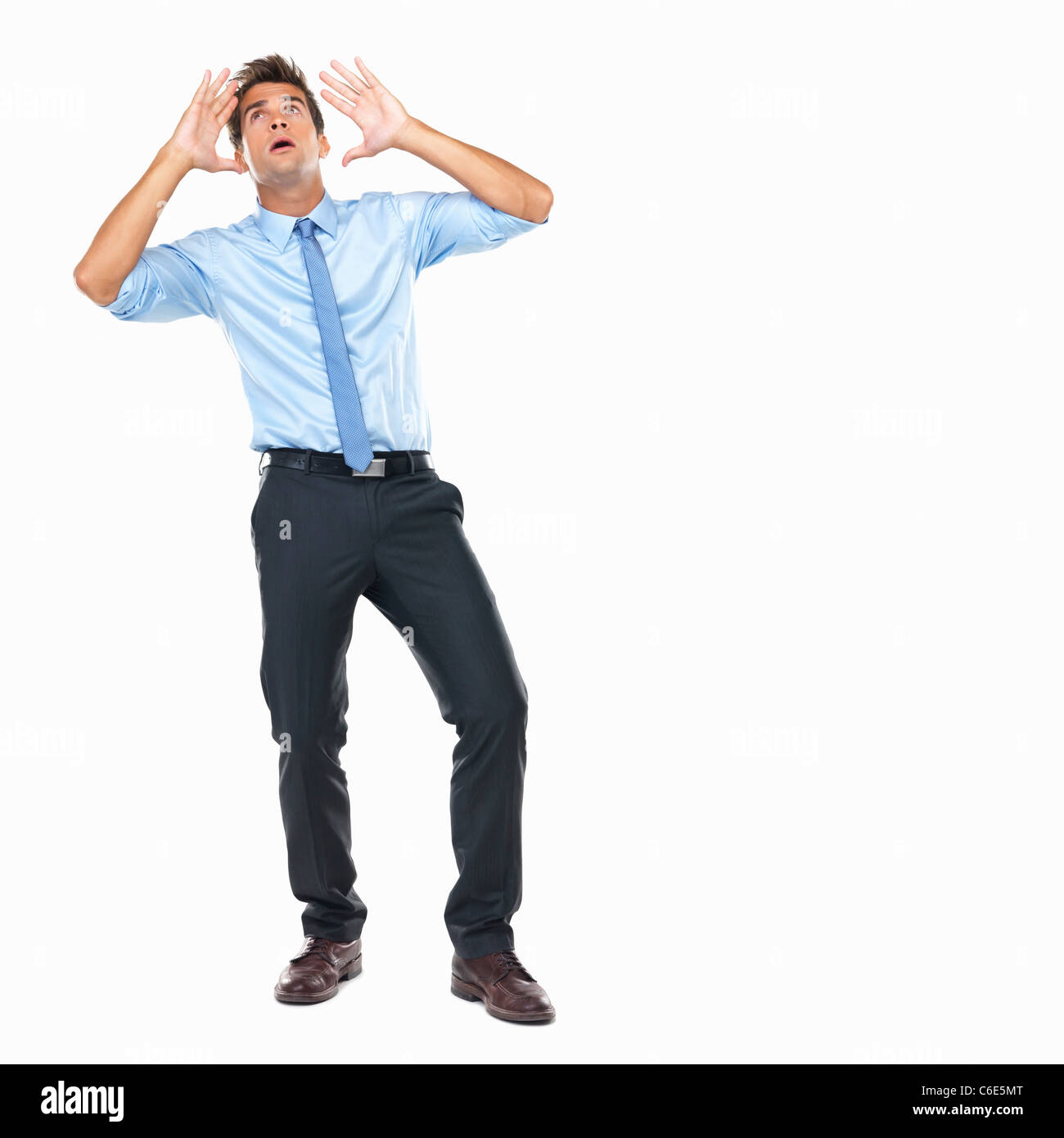 Studio shot of overwhelmed business man looking up Stock Photo - Alamy