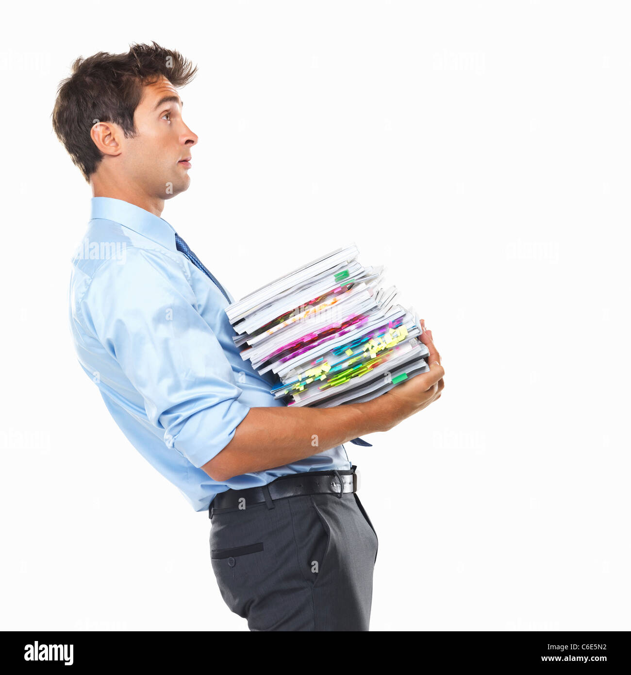 Studio shot of smart business man carrying heavy documents Stock Photo ...
