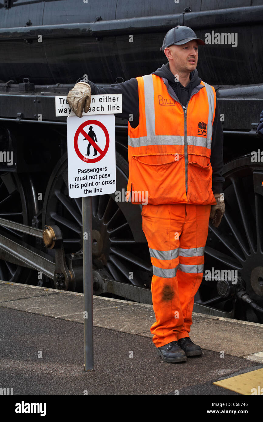 EWS railway crew leant against sign Trains run either way on each line ...