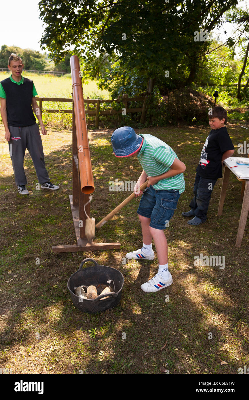An eleven year old boy plays smack the rat at a village fete in Weston ...