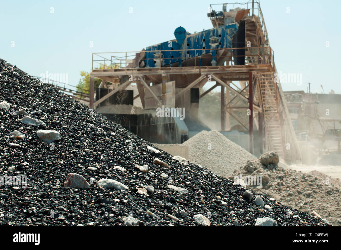 Stone quarry of limestone.Black asphalt pile the fore Stock Photo - Alamy
