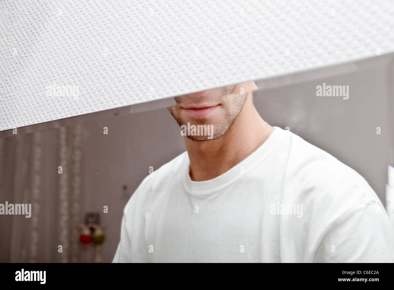 Reflection of half face of young handsome man Stock Photo - Alamy