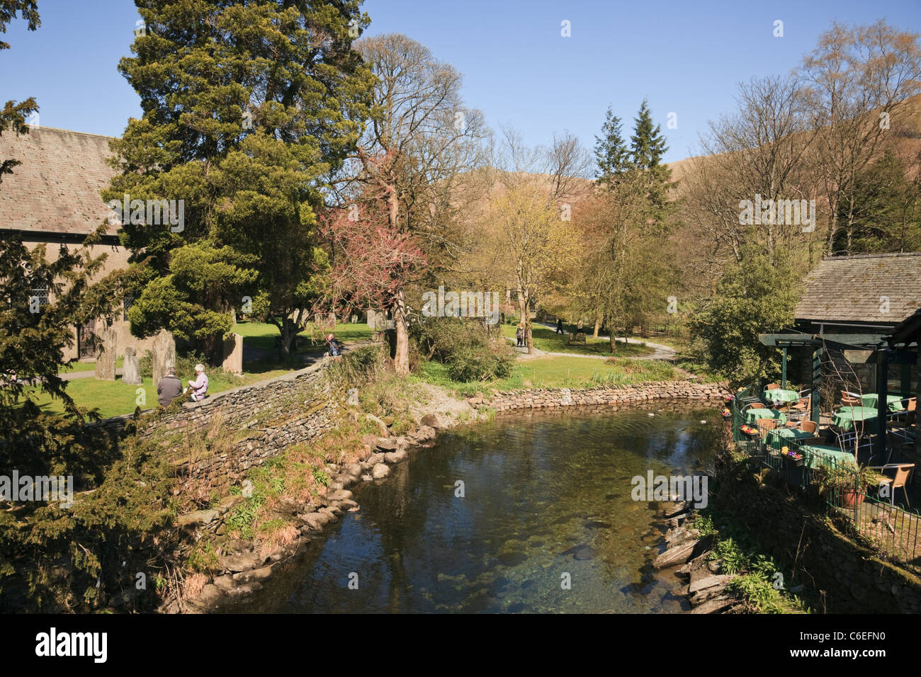 Grasmere, Cumbria, UK. View along River Rothay with St Oswald's Church ...