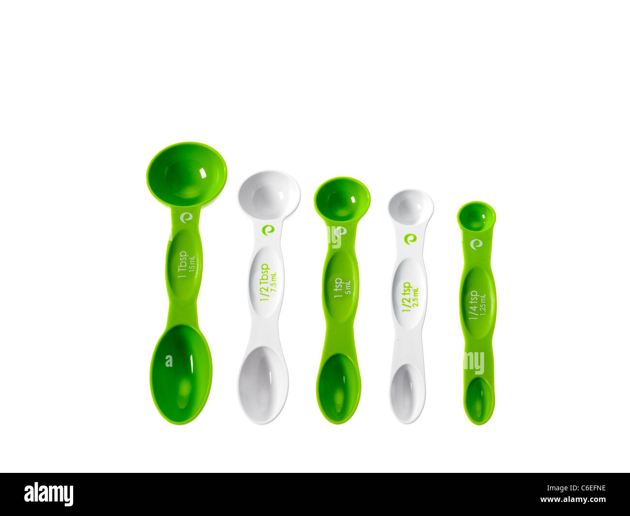 Studio shot of row of green measuring spoons Stock Photo - Alamy