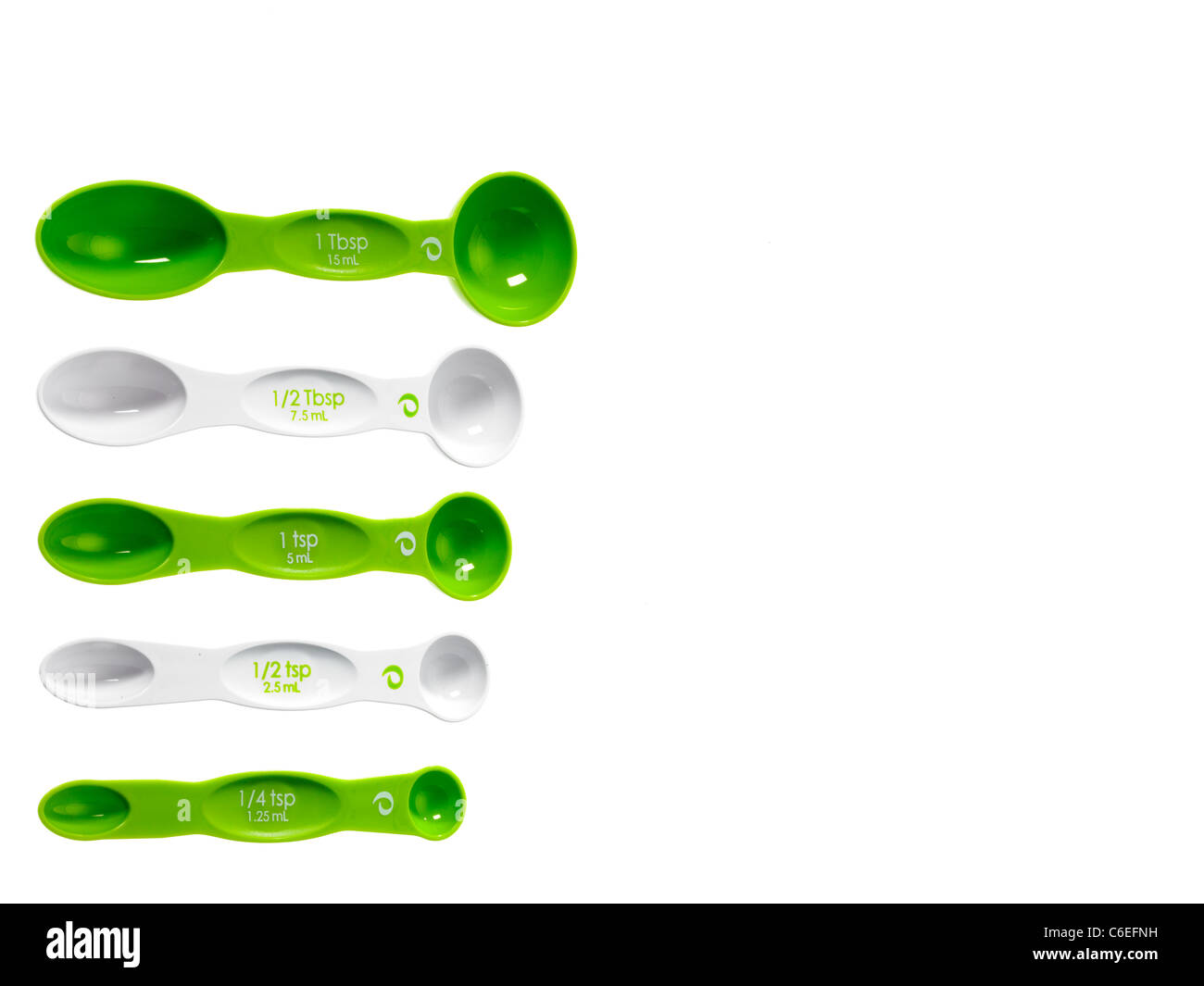 Studio shot of row of green measuring spoons Stock Photo - Alamy