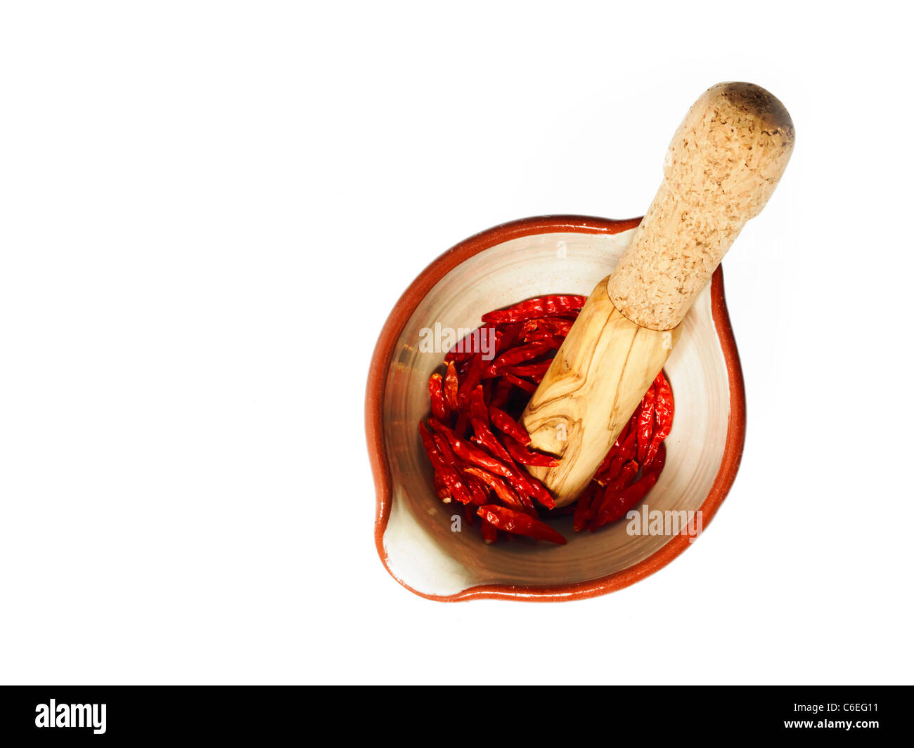 Studio shot of Mortar and Pestle with Red Chili Peppers on white ...