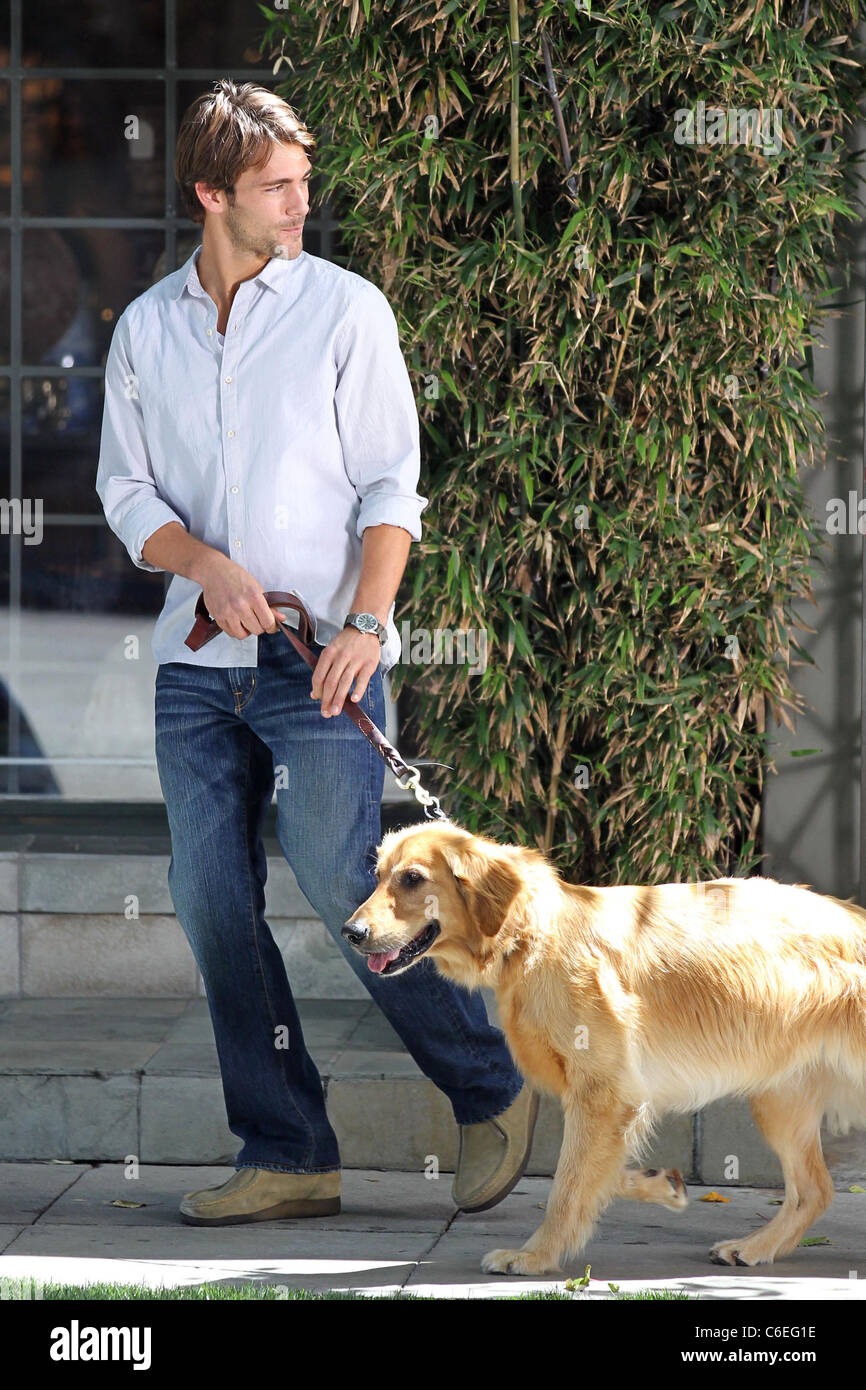 An actor walks a dog on a film set in West Hollywood. Los Angeles ...