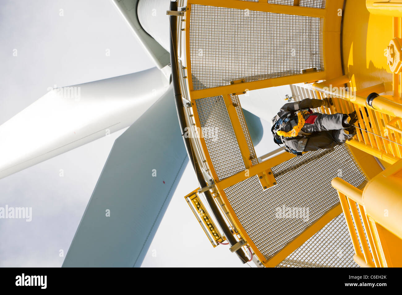 An engineer on a transition piece of a wind turbine on the Walney ...