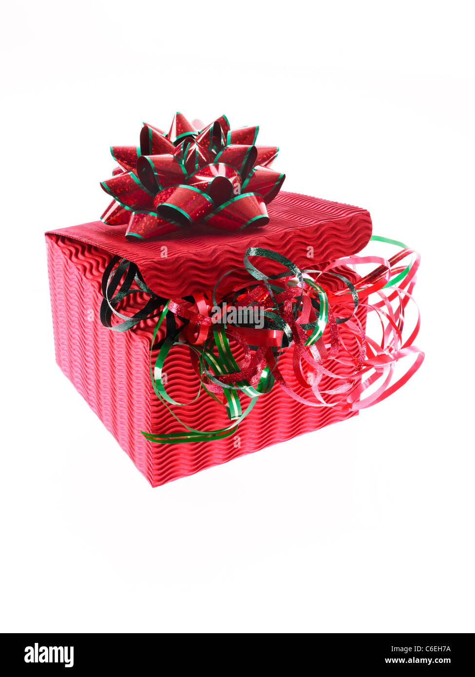 Studio shot of Red Box and Red and Green Ribbon on white background ...