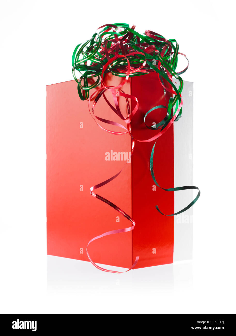 Studio shot of Red Box and Red and Green Ribbon on white background ...