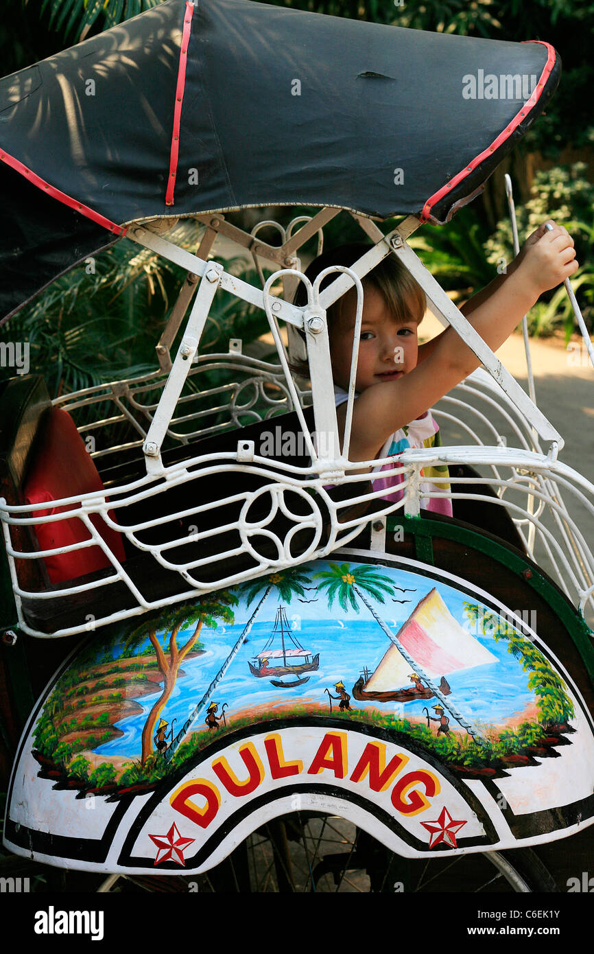 A young girl sitting in a rickshaw Stock Photo - Alamy