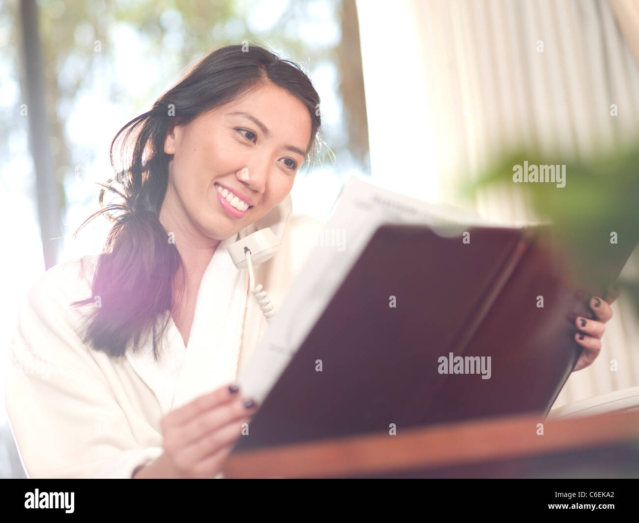 USA, Arizona, Scottsdale, Woman ordering room service in hotel Stock ...