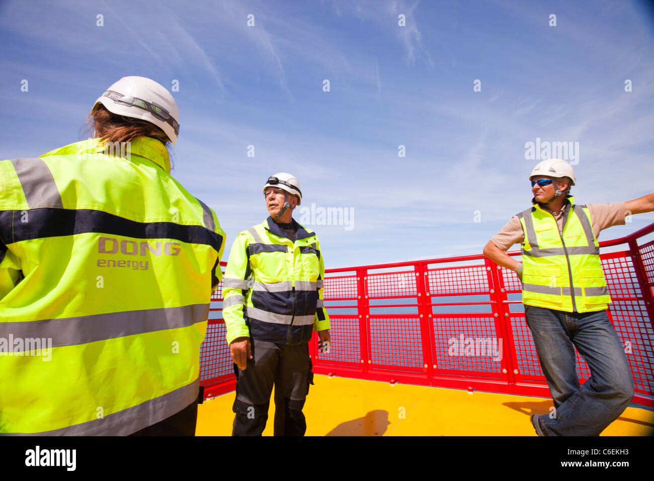 Workers on the heli pad on top of a 300 foot high wind turbine in the ...
