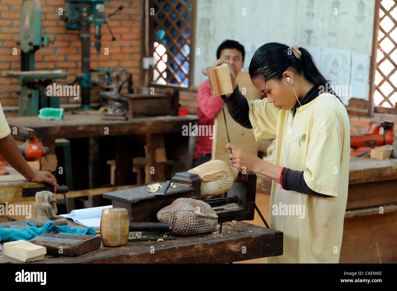 woman carving carve make making stone head workshop siem reap cambodia ...