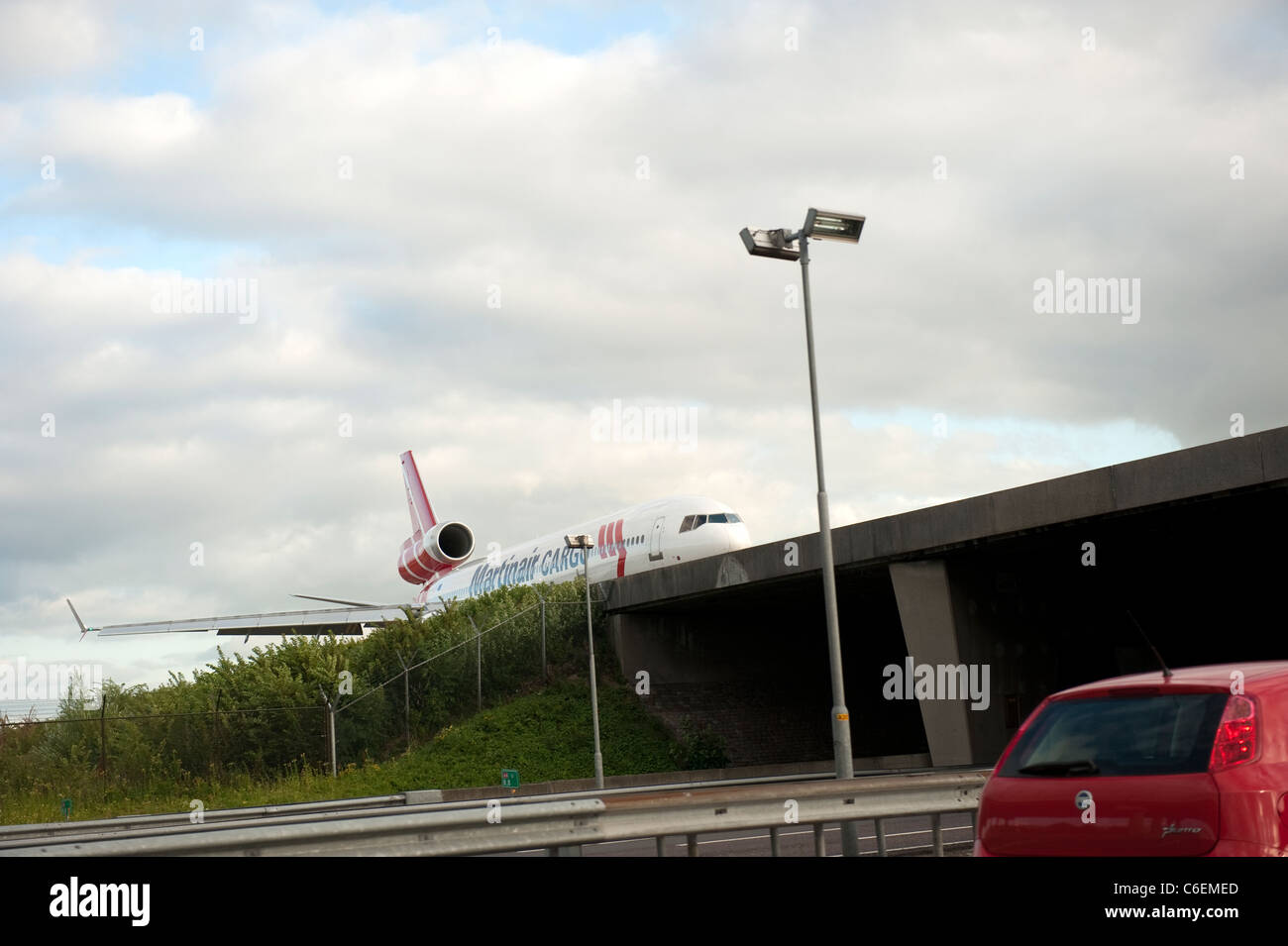 Plane over road runway Airport Schiphol Amsterdam Stock Photo - Alamy