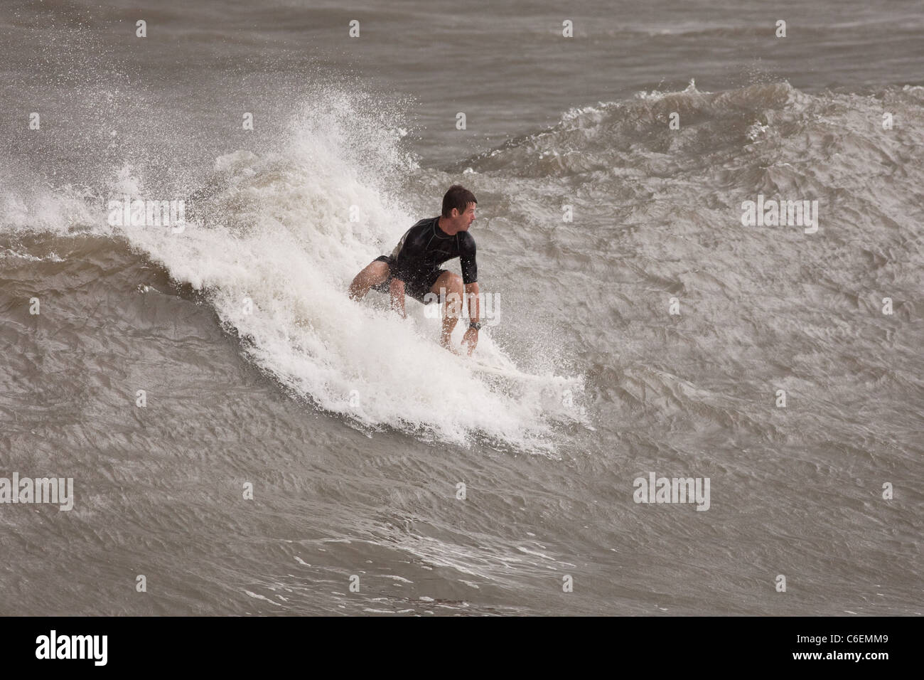 A surfer takes advantage of 14-foot waves churned up by passing ...
