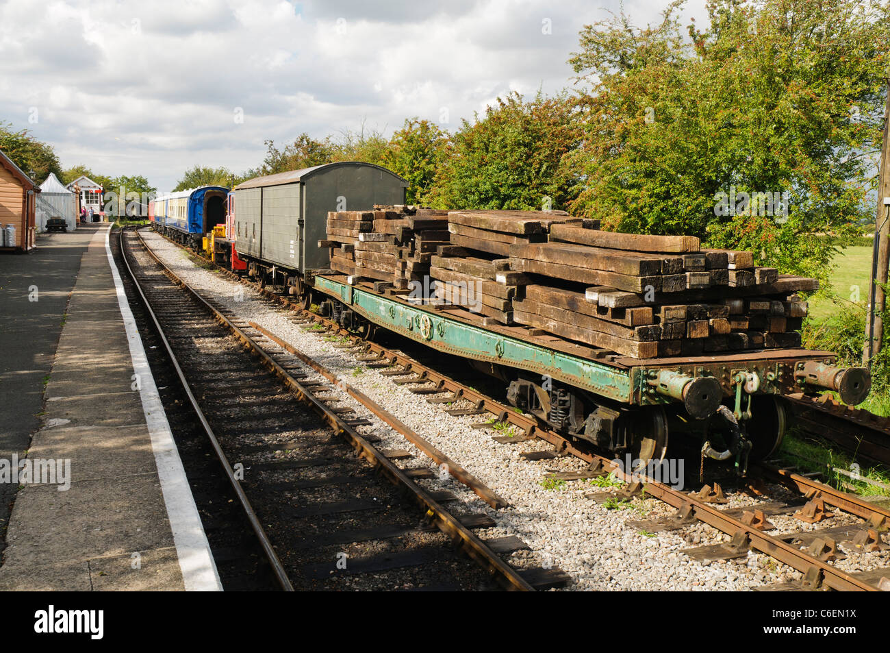 Old fashioned freight carriages including one carrying sleepers at the ...