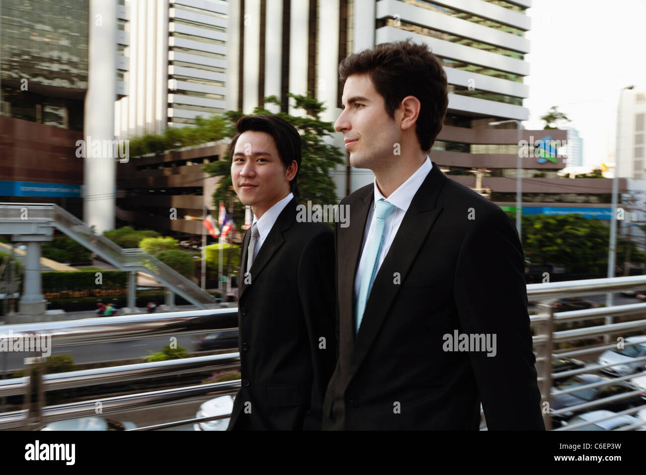 Businessmen walking together outdoors Stock Photo - Alamy