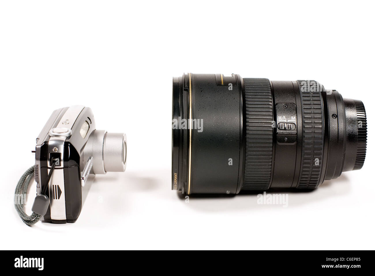 The small camera and the big lens it is isolated on a white background ...